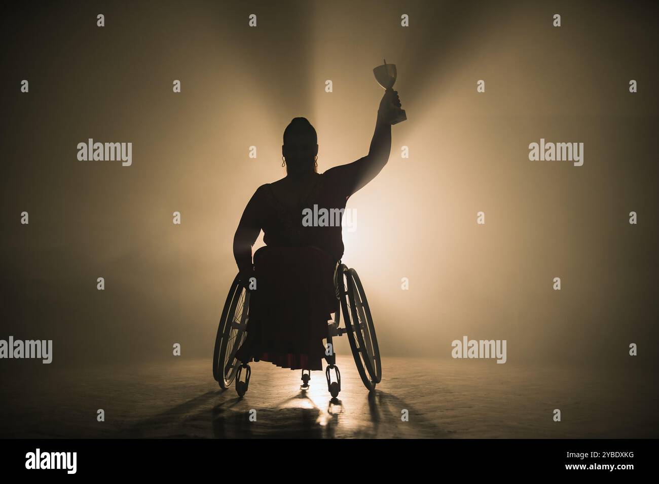 Woman with disability hoisting a trophy in the air to celebrate a ...