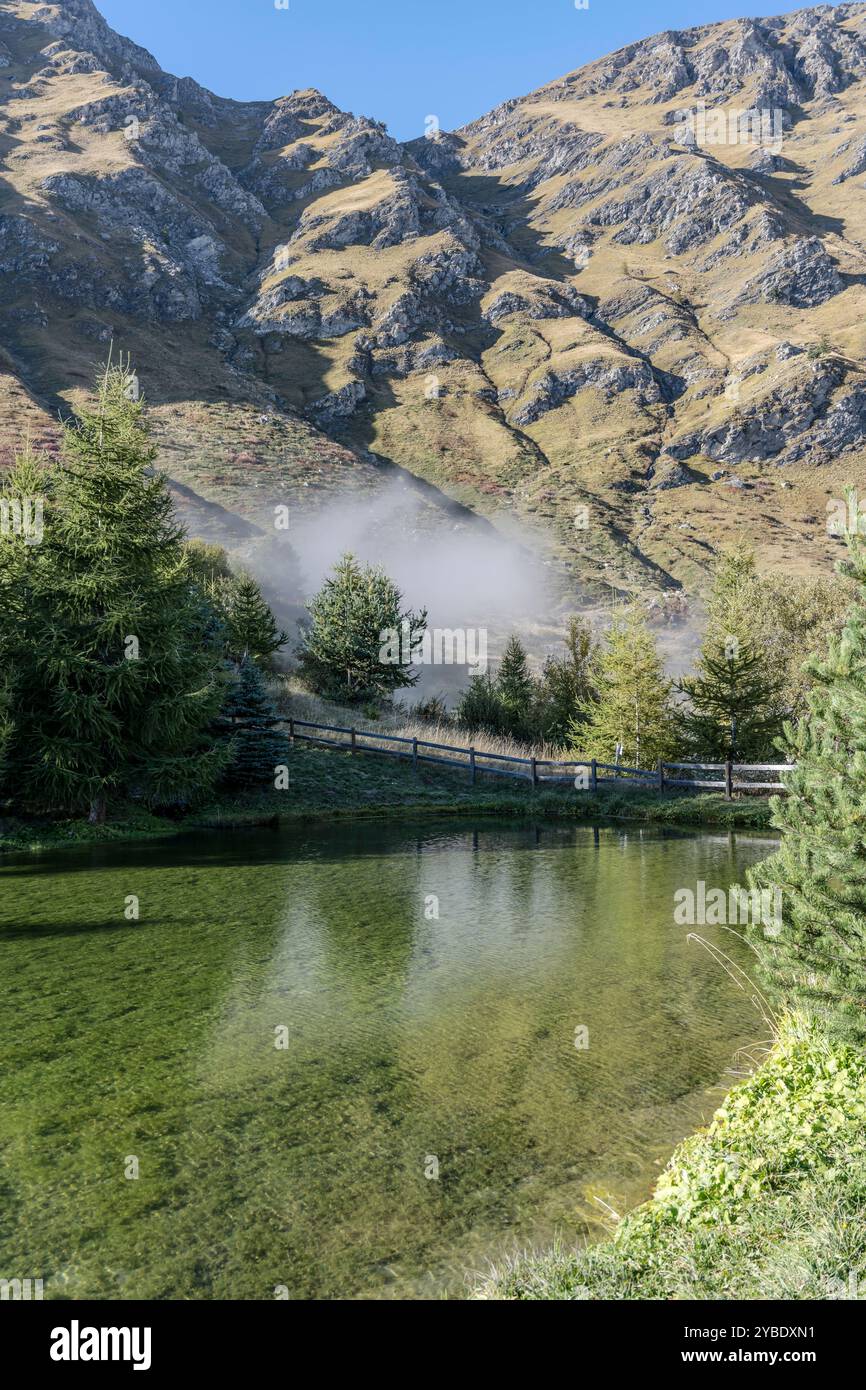 landscape with low cloud and Pintas peak slopes reflecting in little ...