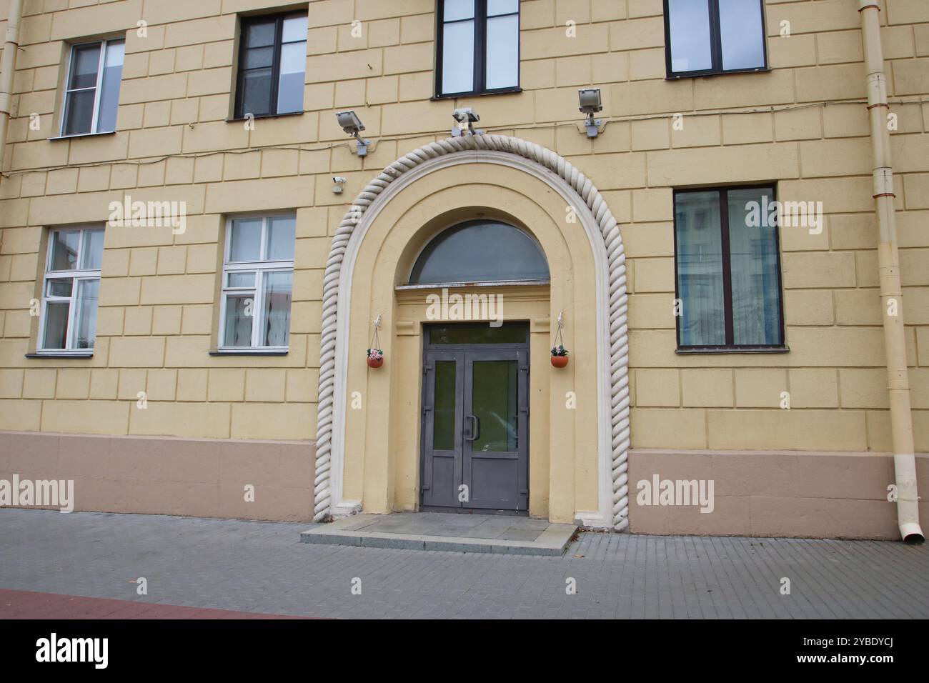 The main entrance to a large building is adorned with an elegant rope ...