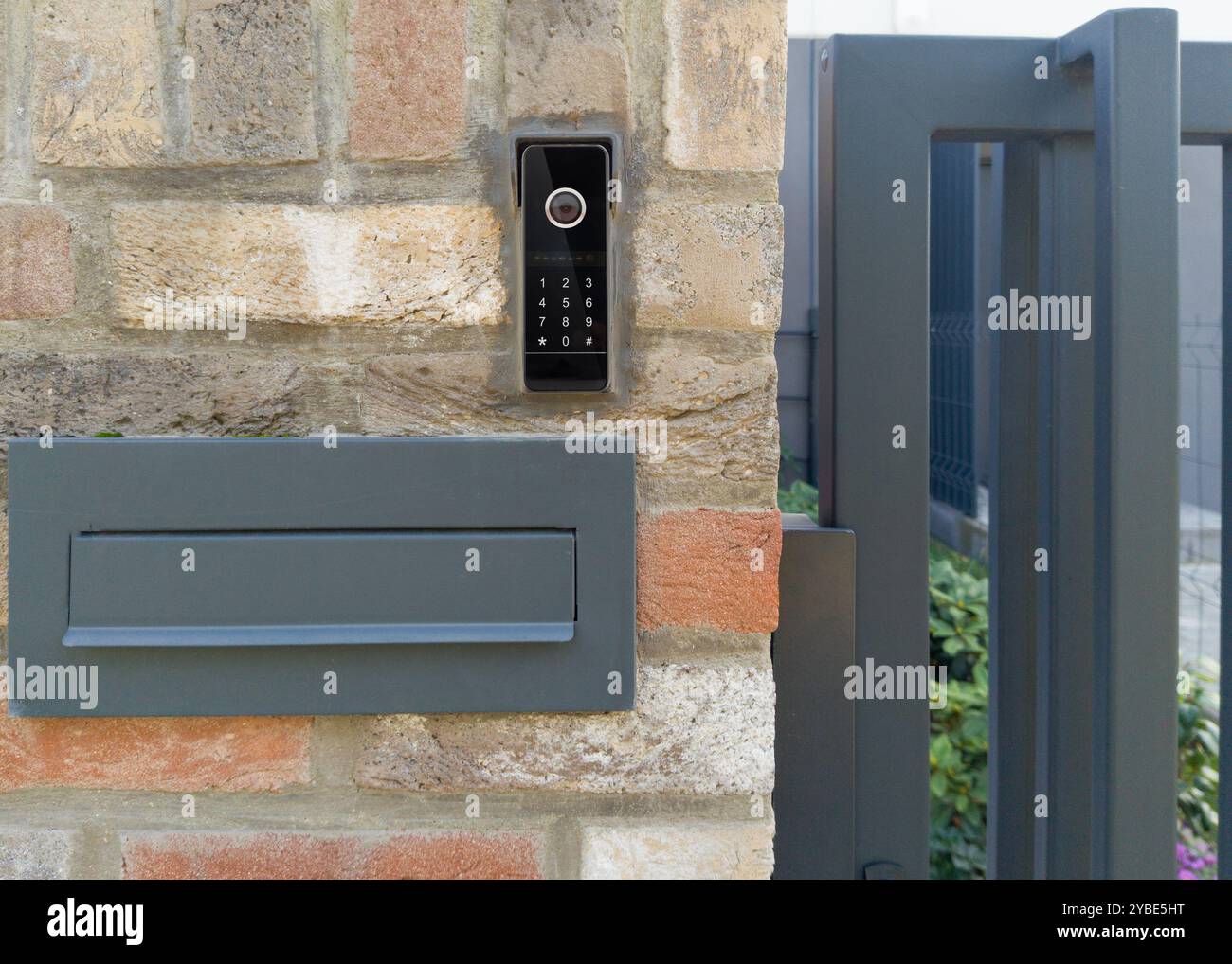 Modern mailbox and video intercom on brick wall Stock Photo - Alamy