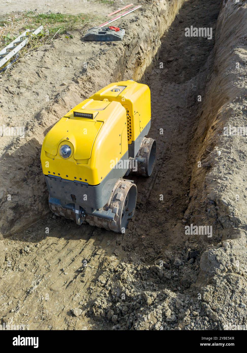 Remote controlled trench roller working on soil compaction Stock Photo ...
