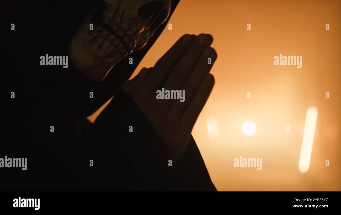 Silhouette Of The Death Skull Praying Stock Photo - Alamy