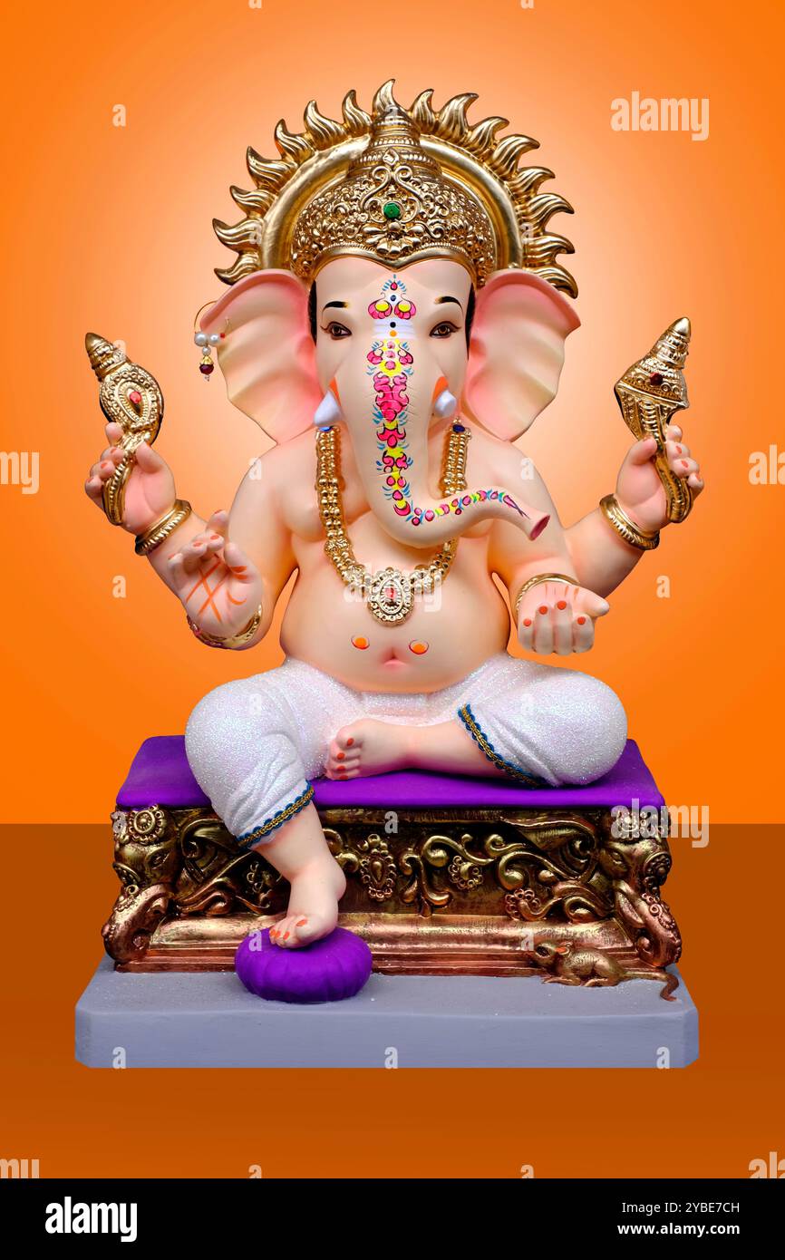 Hindu God Ganesha on orange background, Ganesha Idol. Ganesh festival ...