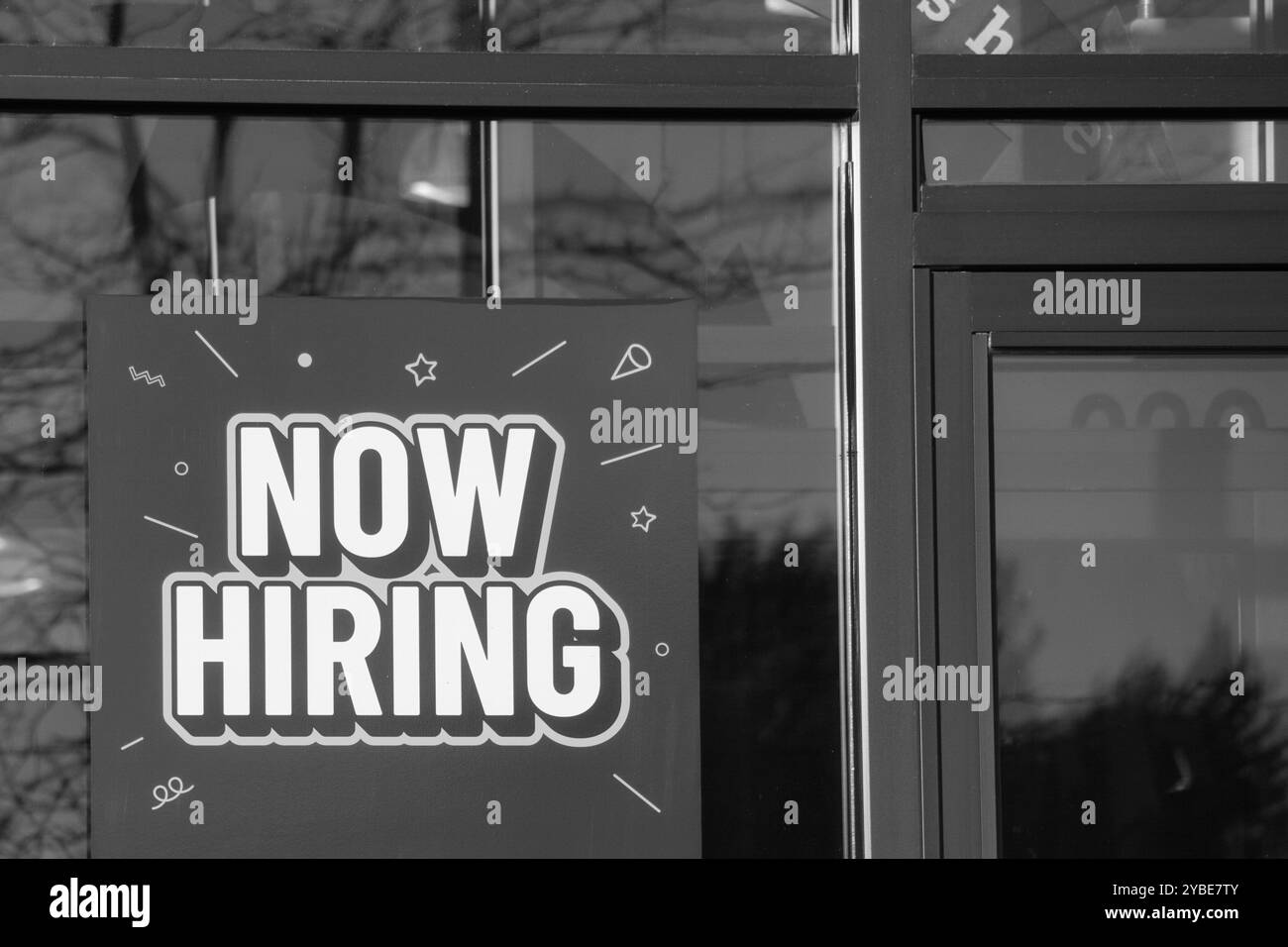 now hiring sign in window Stock Photo - Alamy