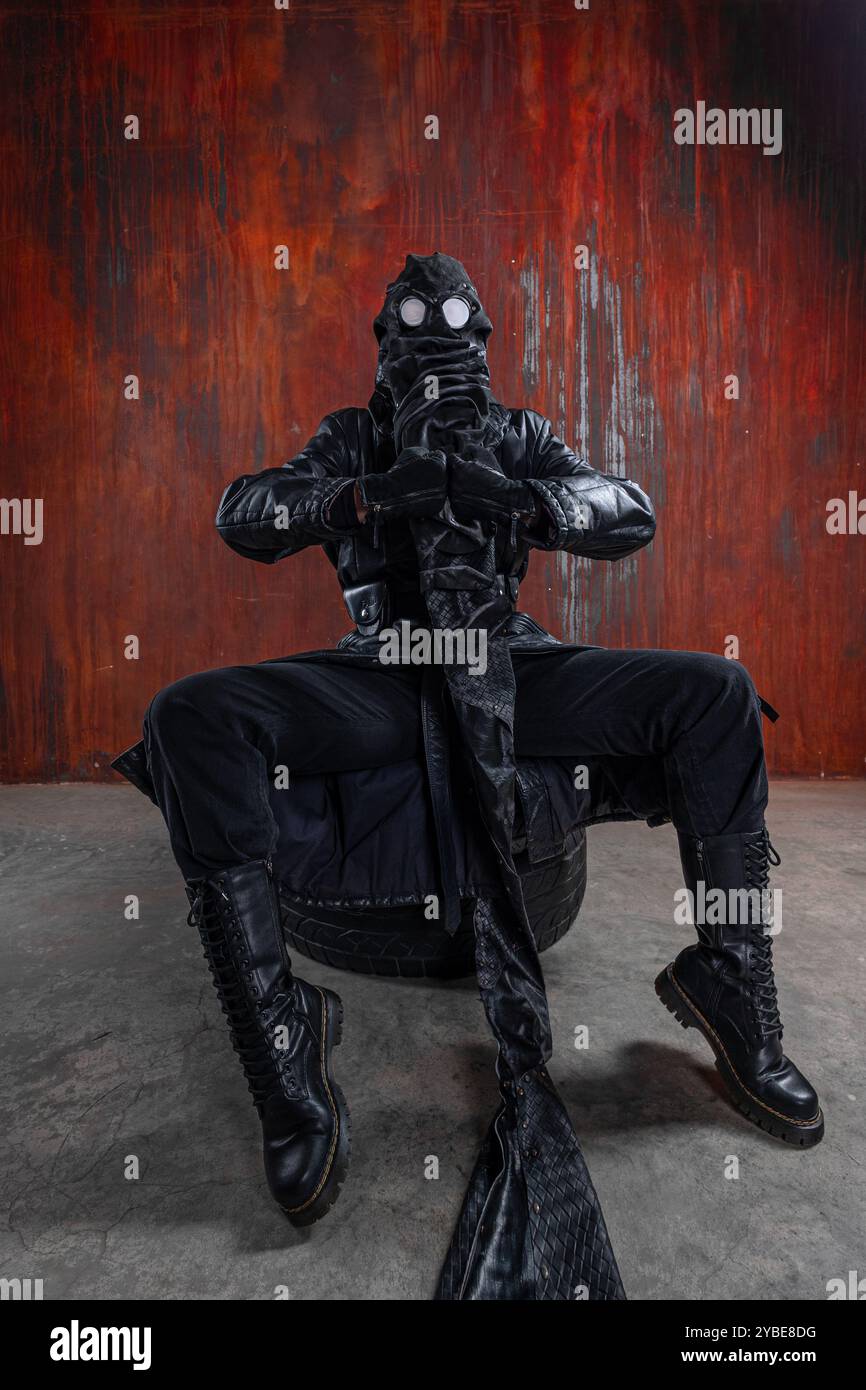 A strange post apocalyptic freak in a leather suit wearing a mask with ...