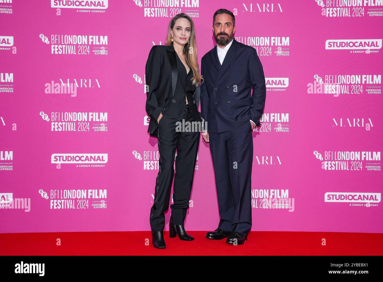 Angelina Jolie, left, and Pablo Larraín pose for photographers upon ...