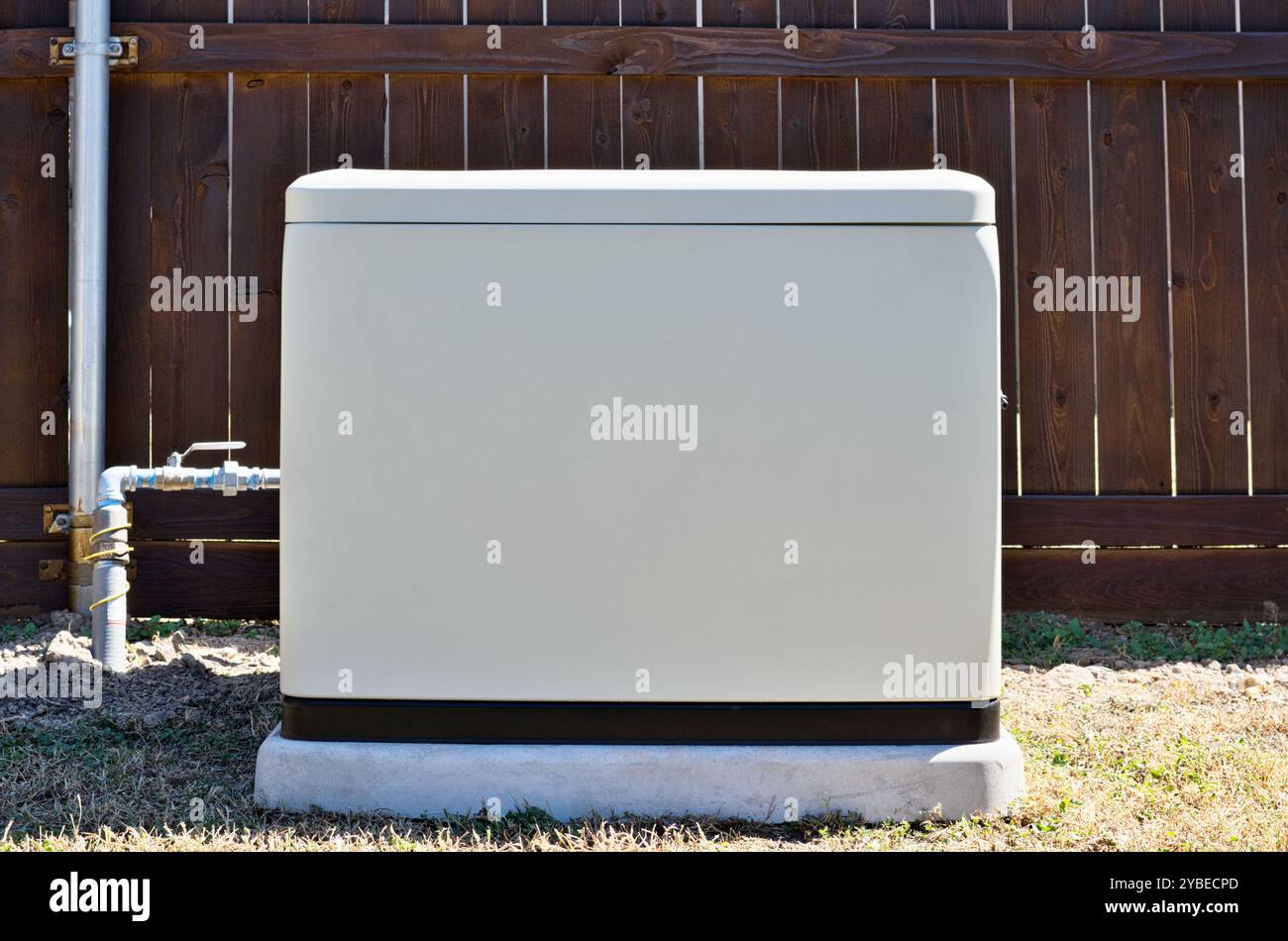 Standby home generator set in residential backyard, emergency backup ...