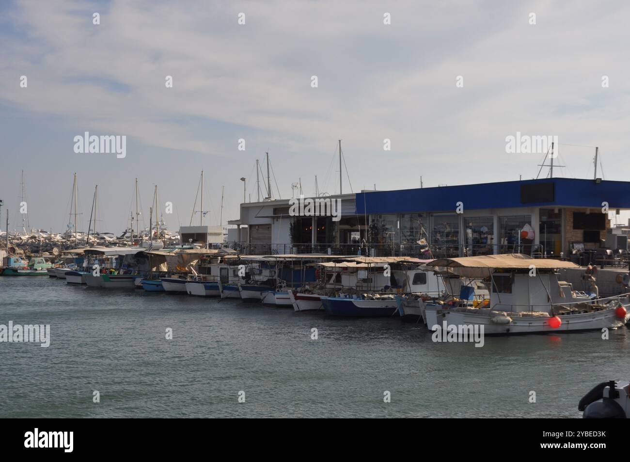 The Limassol Old Port with fishing boats and beautiful buildings in ...