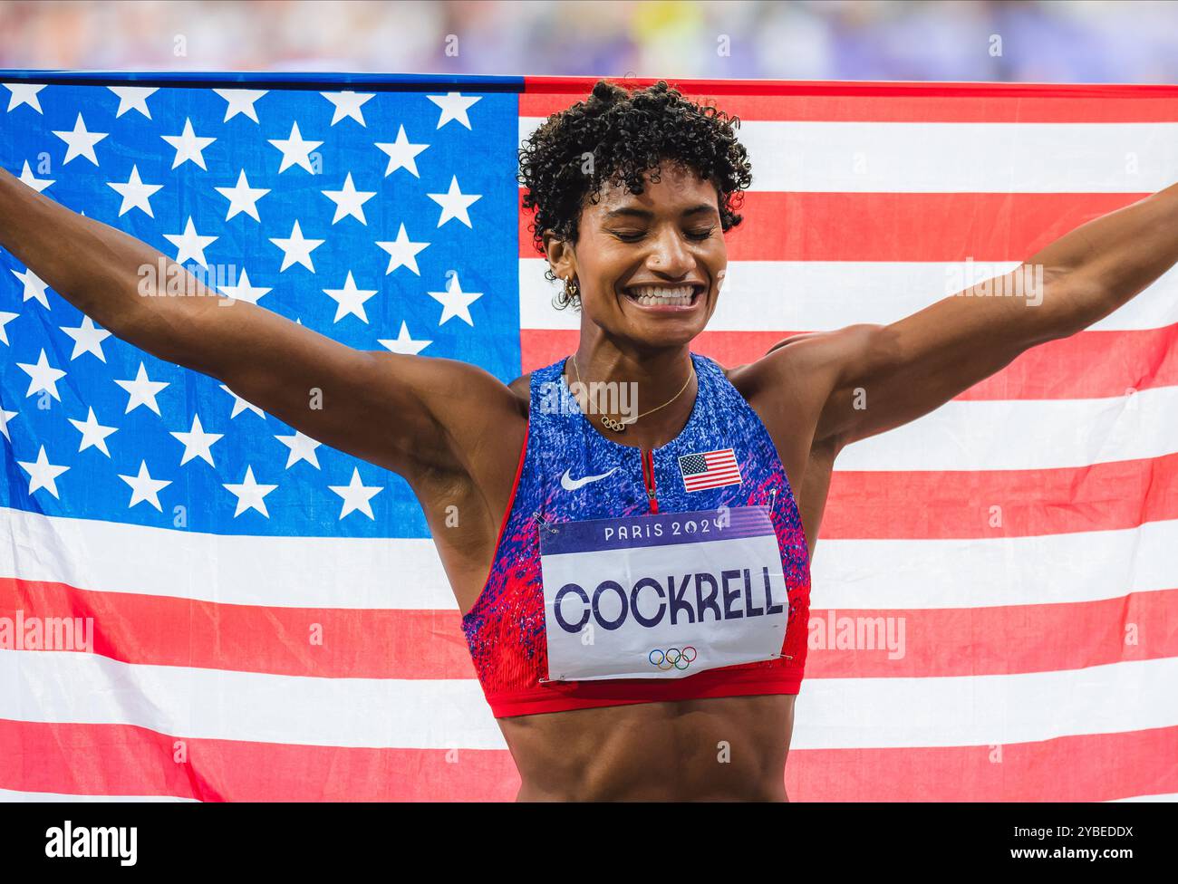 Anna Cockrell celebrating with her country's flag in the 400 meters ...