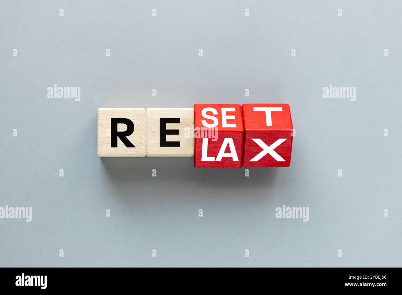 Reset symbol. Rotating wooden cubes changes the word "reset" to "relax ...