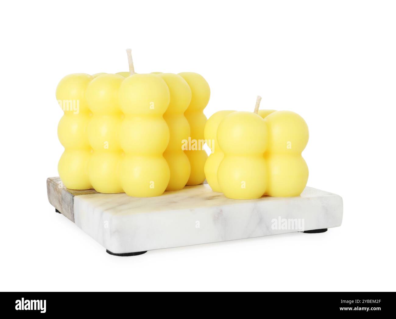 Two yellow bubble candles isolated on white Stock Photo - Alamy