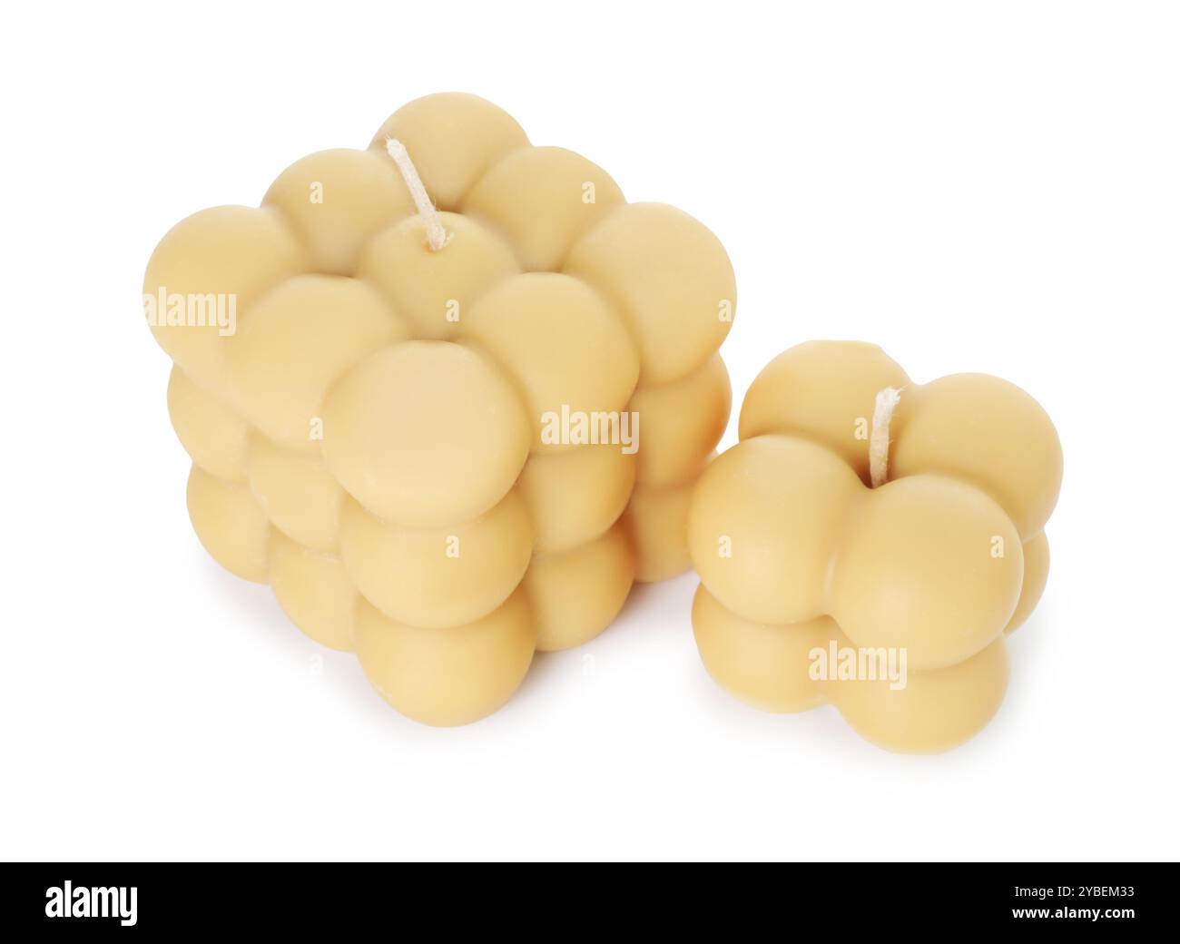 Two beige bubble candles isolated on white Stock Photo - Alamy