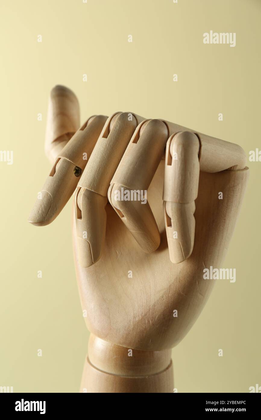 Wooden mannequin hand on beige background, closeup Stock Photo - Alamy