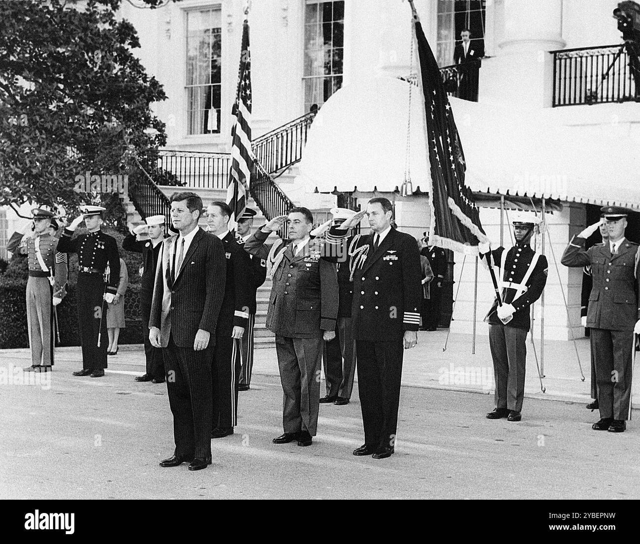U.S. President John F. Kennedy (left, foreground) attending military ...
