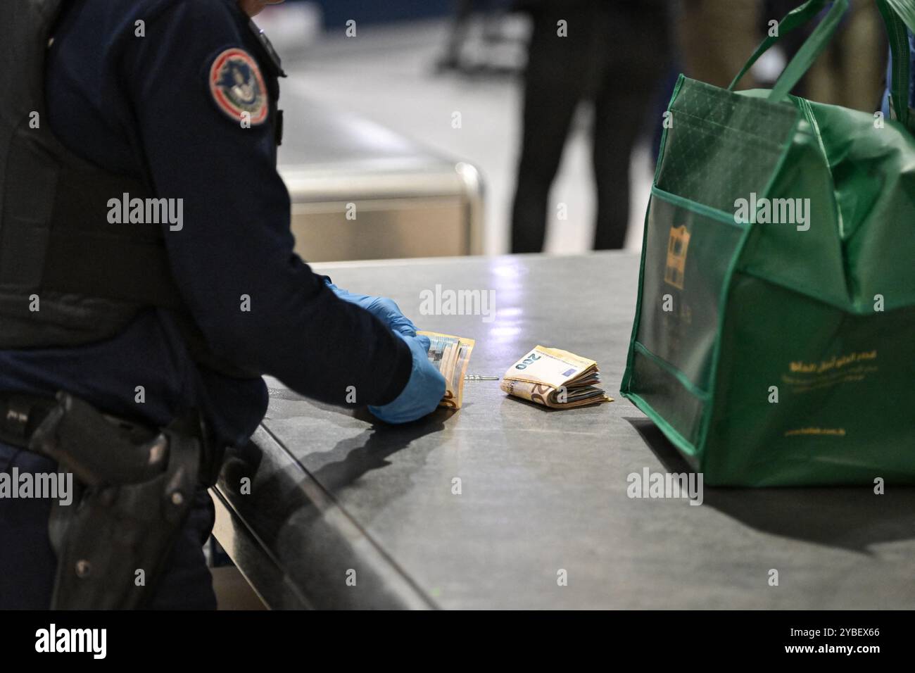 A Customs officer checks money during French Minister of the Budget and ...