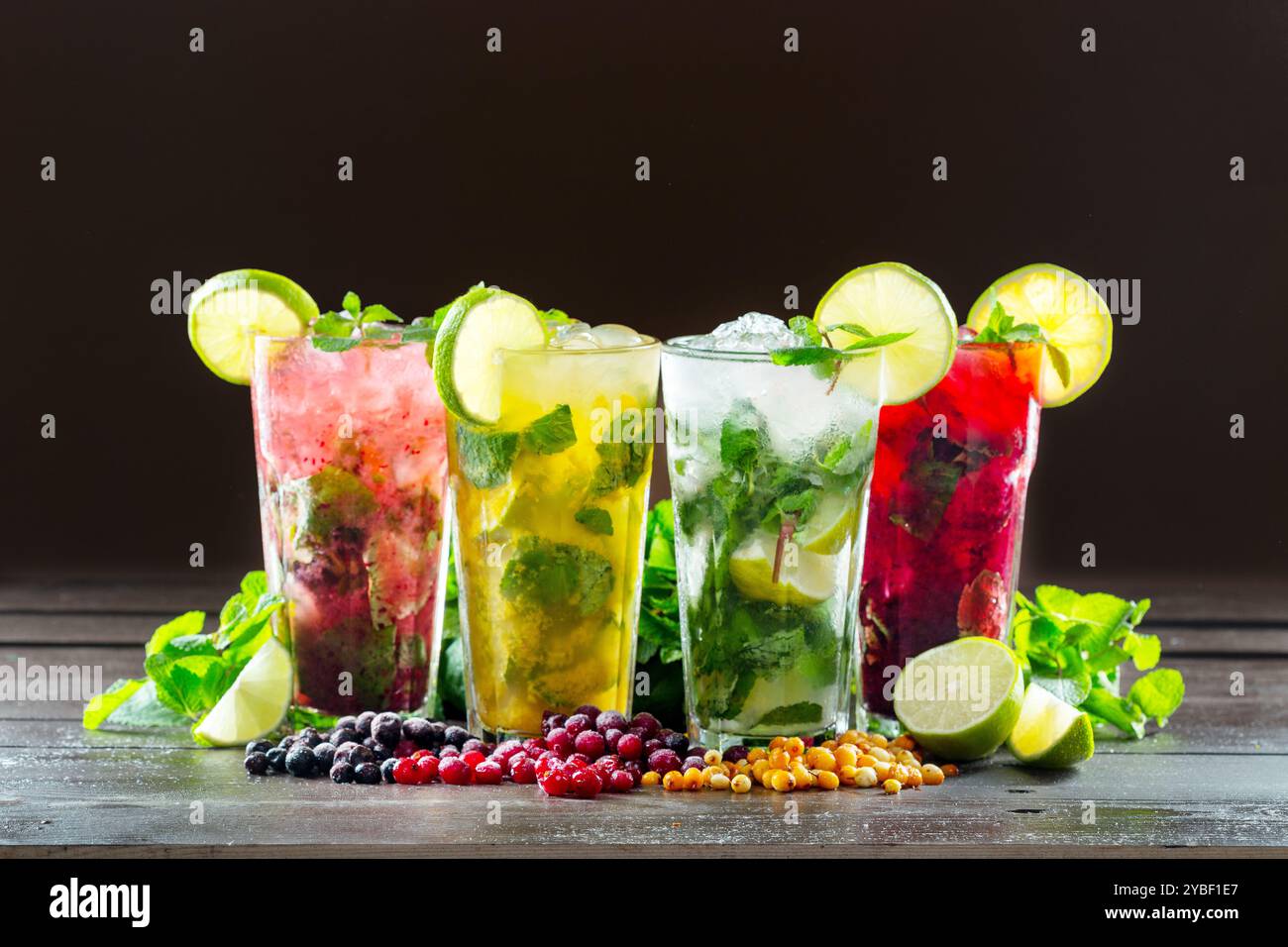 Different types of mojito cocktail on dark brown background Stock Photo ...