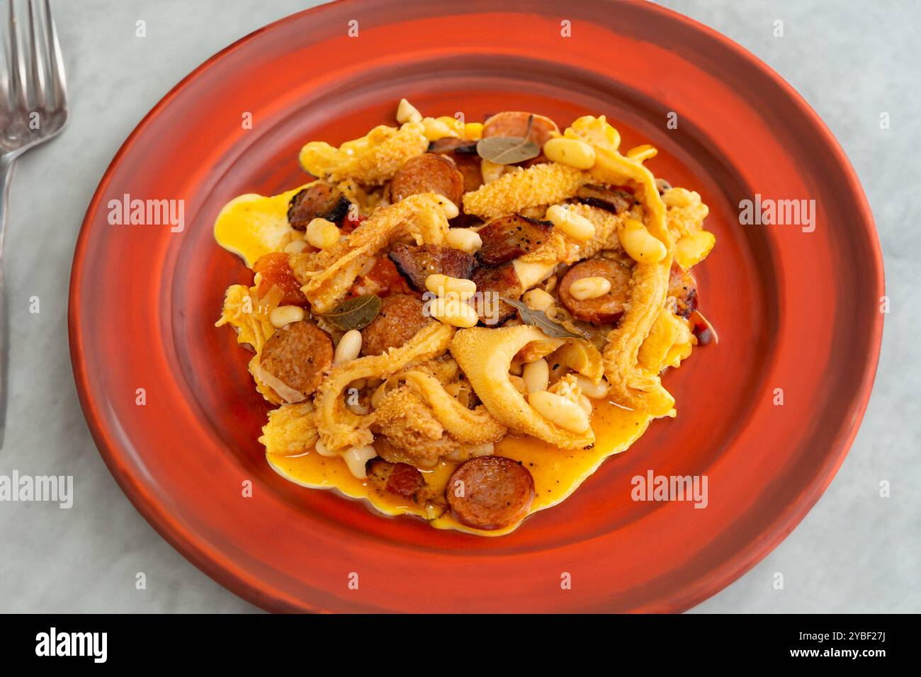 Beef tripe (bucho), beef stomach, tripe on a white plate. Dobradinha ...