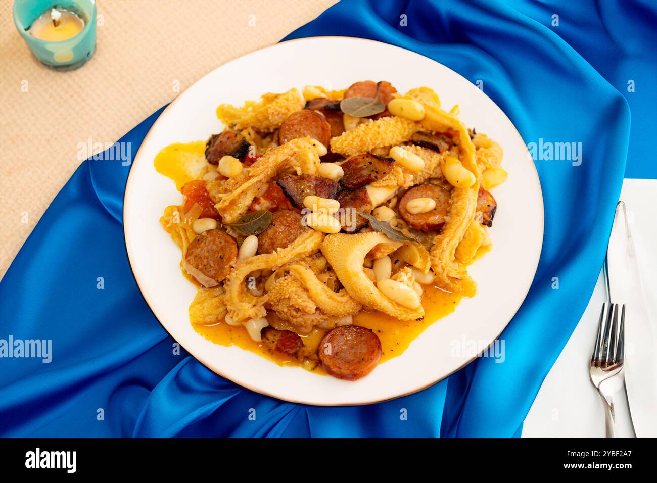 Beef tripe (bucho), beef stomach, tripe on a white plate. Dobradinha ...