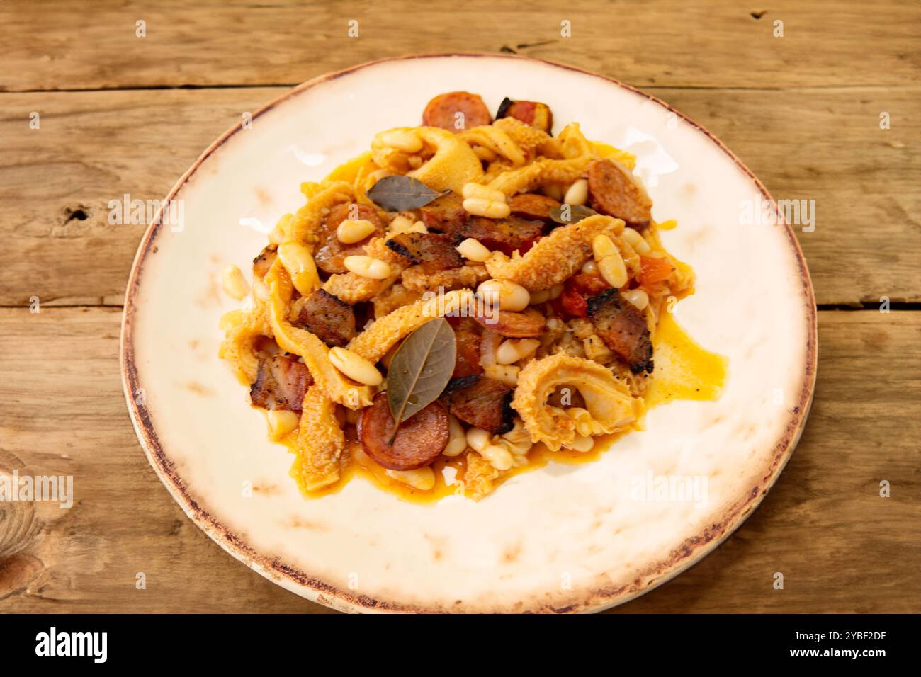 Beef tripe (bucho), beef stomach, tripe on a white plate. Dobradinha ...