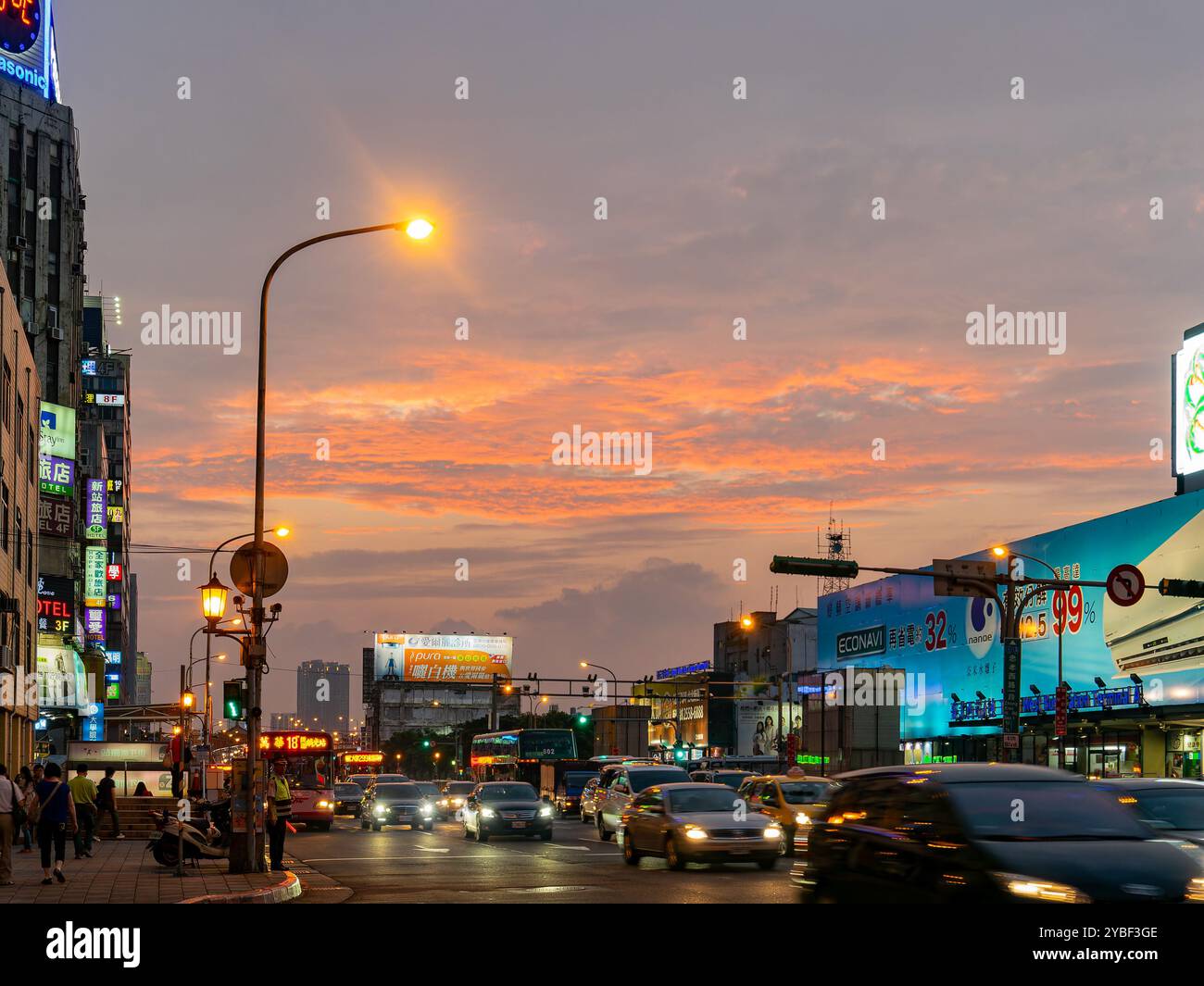 Taipei, JUN 13 2014 - Sunset streetscape with many people walking and traffic Stock Photo - Alamy