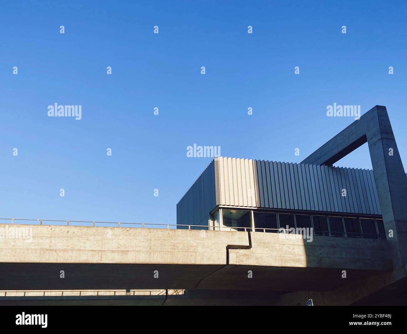 Modern architectural structure under a clear blue sky with a sleek ...