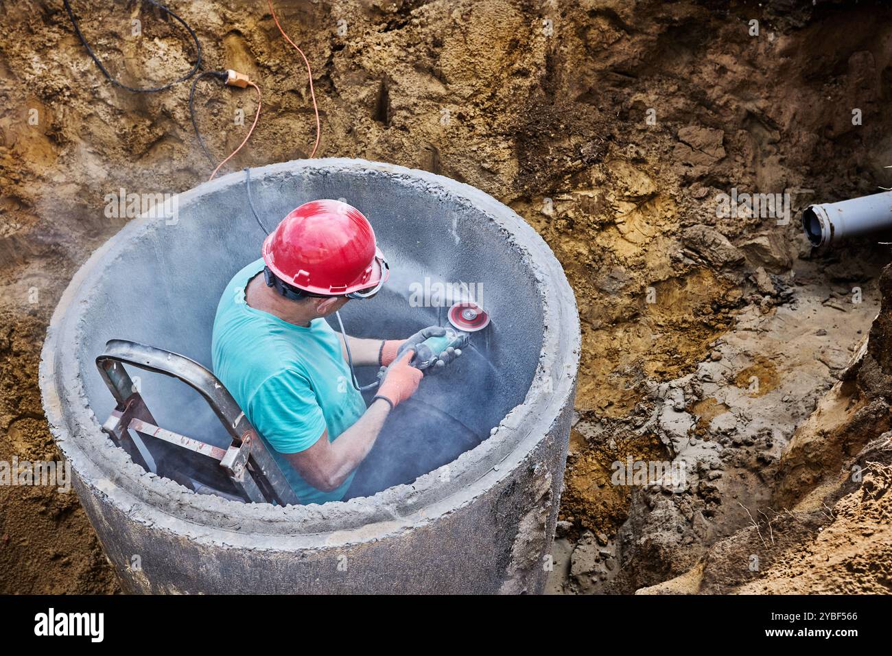 Diamond concrete cutting wheel is mounted on an angle grinder while ...