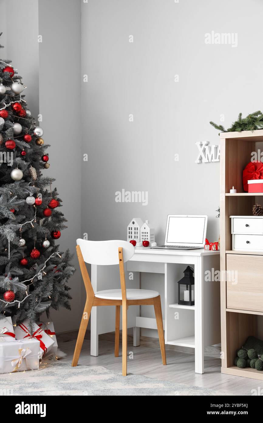 Interior of office with workplace and Christmas tree Stock Photo - Alamy