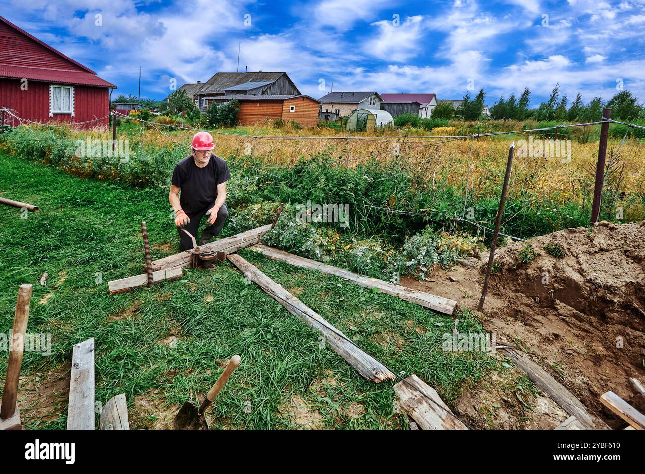 Rigging work on country site, using manual winch with gear mechanism ...