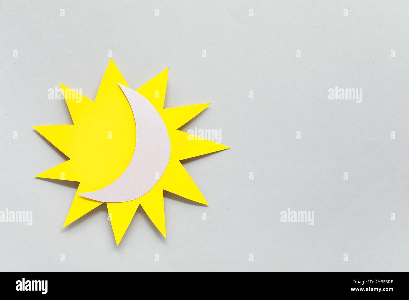 Paper sun with crescent on light background. Winter solstice concept ...
