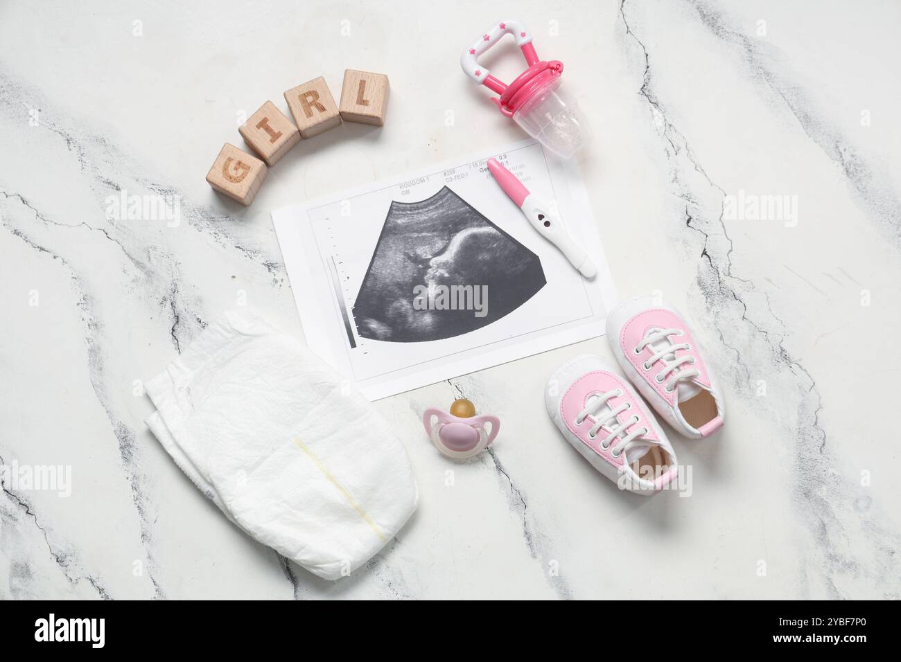 Composition with baby shoes, sonogram image, pregnancy test and word ...