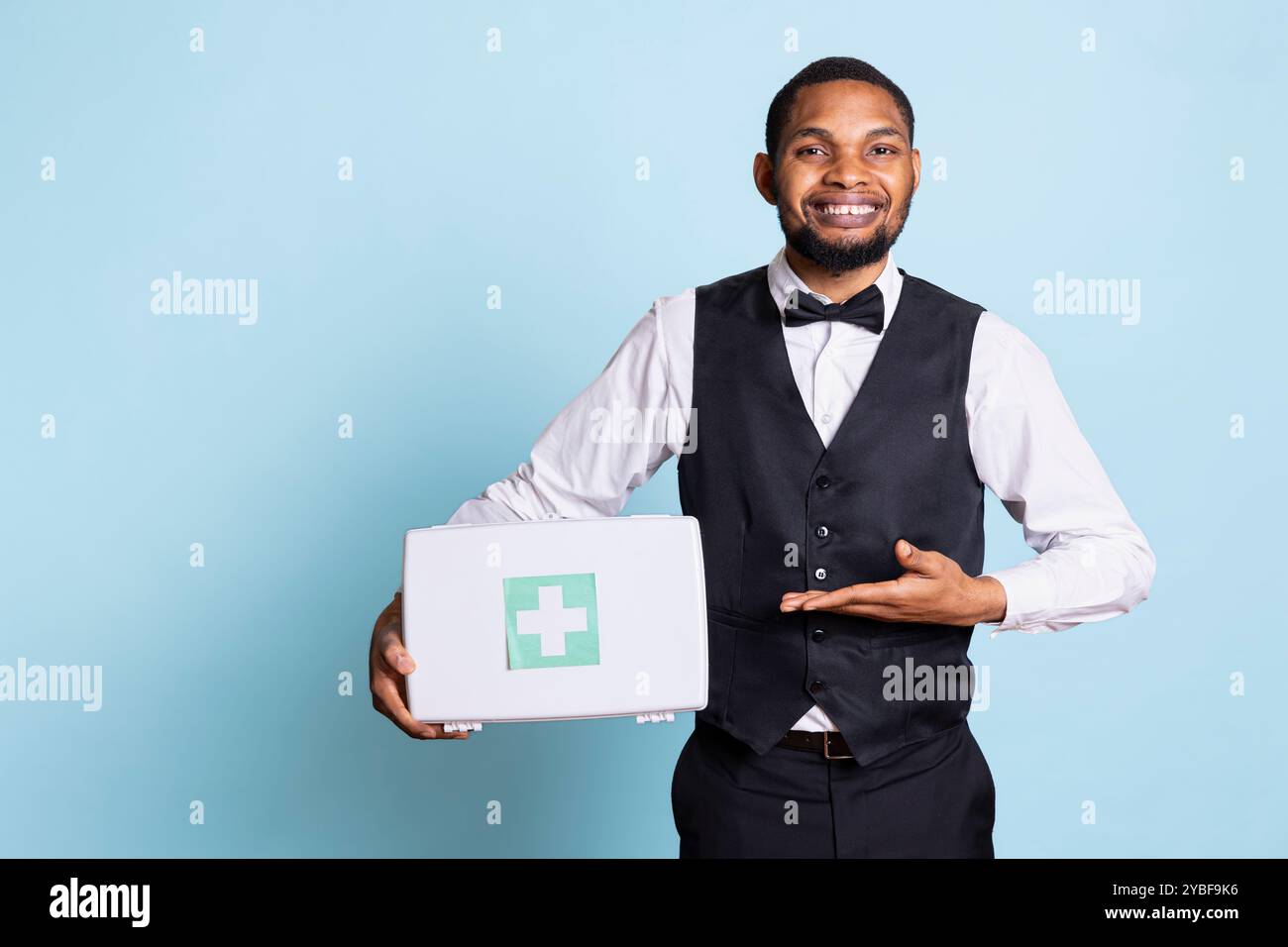 Hotel porter employee presenting a first aid kit used for medical ...