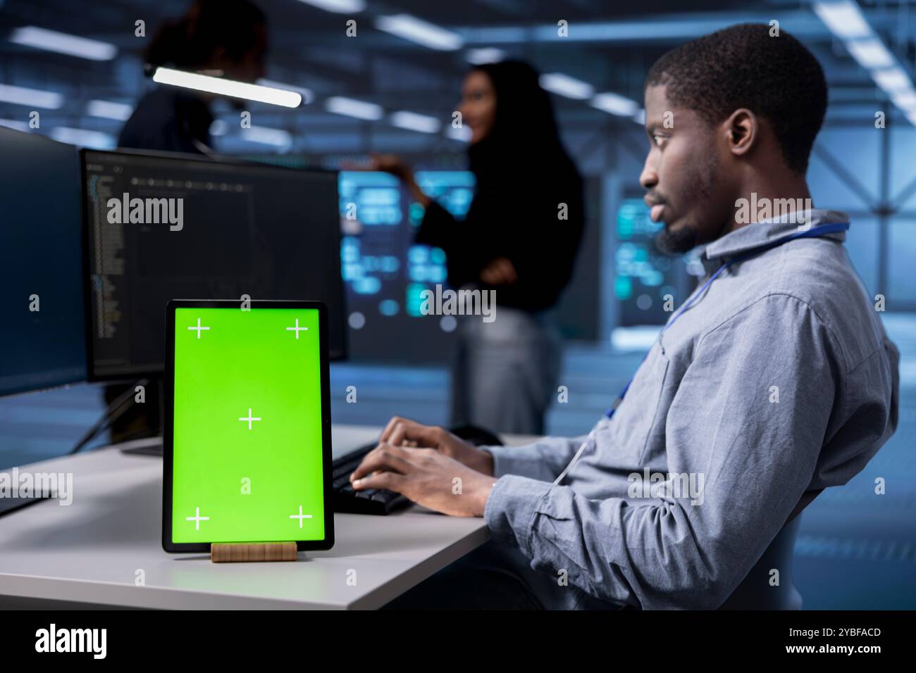 Supervisor Using Chroma Key Tablet To Reconfigure Server Room Optimizing It For Data Processing