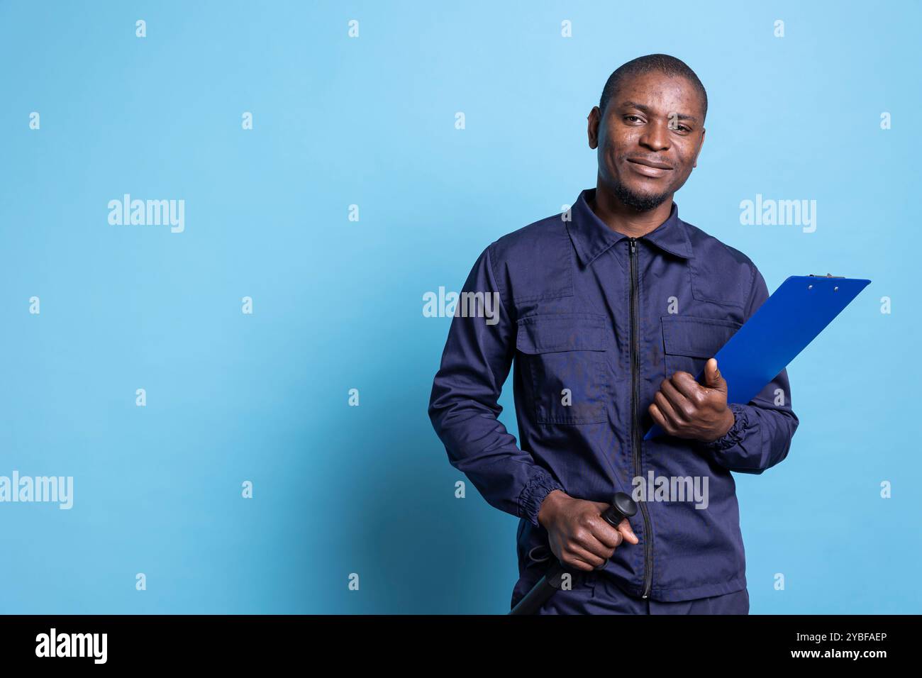 Security officer in uniform holding a checklist on papers and his baton ...