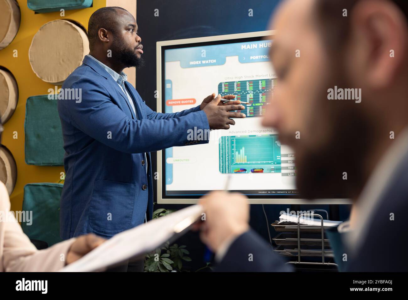 Office administrator showing statistics on interactive board in a ...