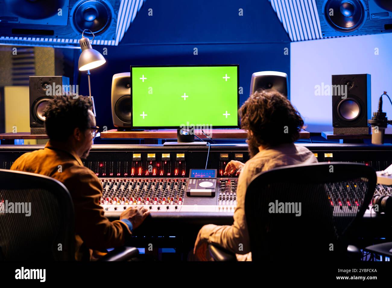 Team of artists mixing and mastering music with greenscreen on pc in ...