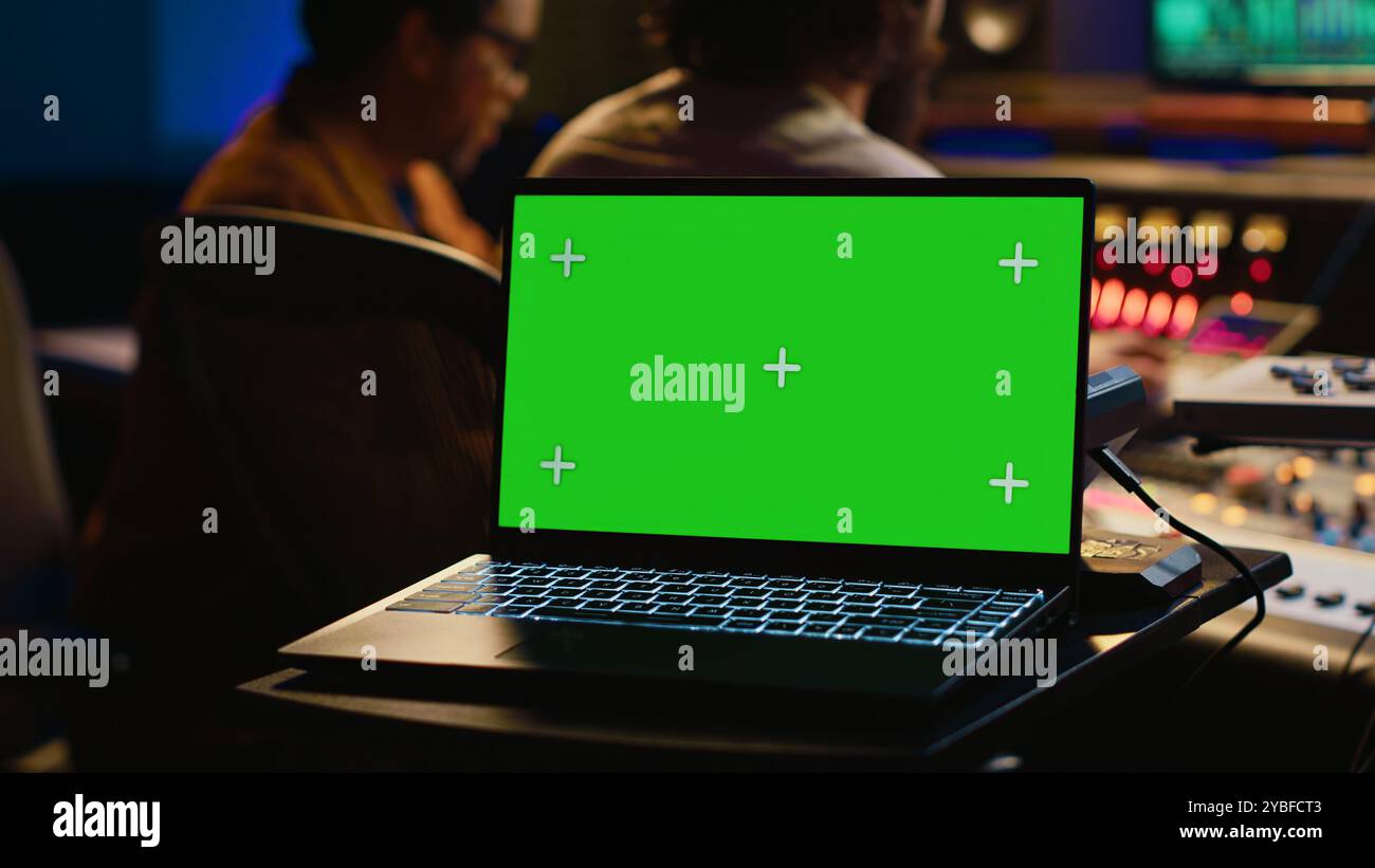 Sound designer and singer look at laptop with isolated display in ...