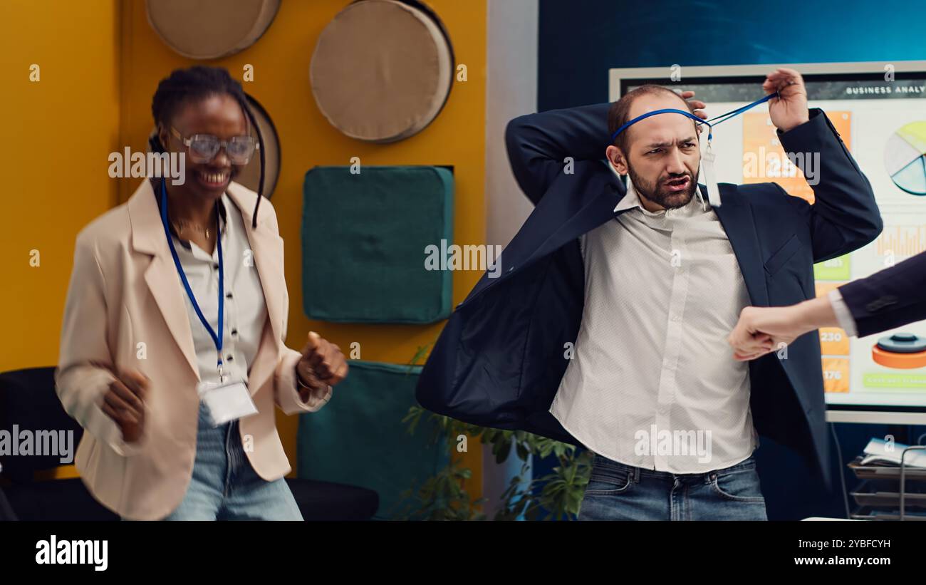 Satisfied coworkers dancing in the boardroom and celebrating a business ...