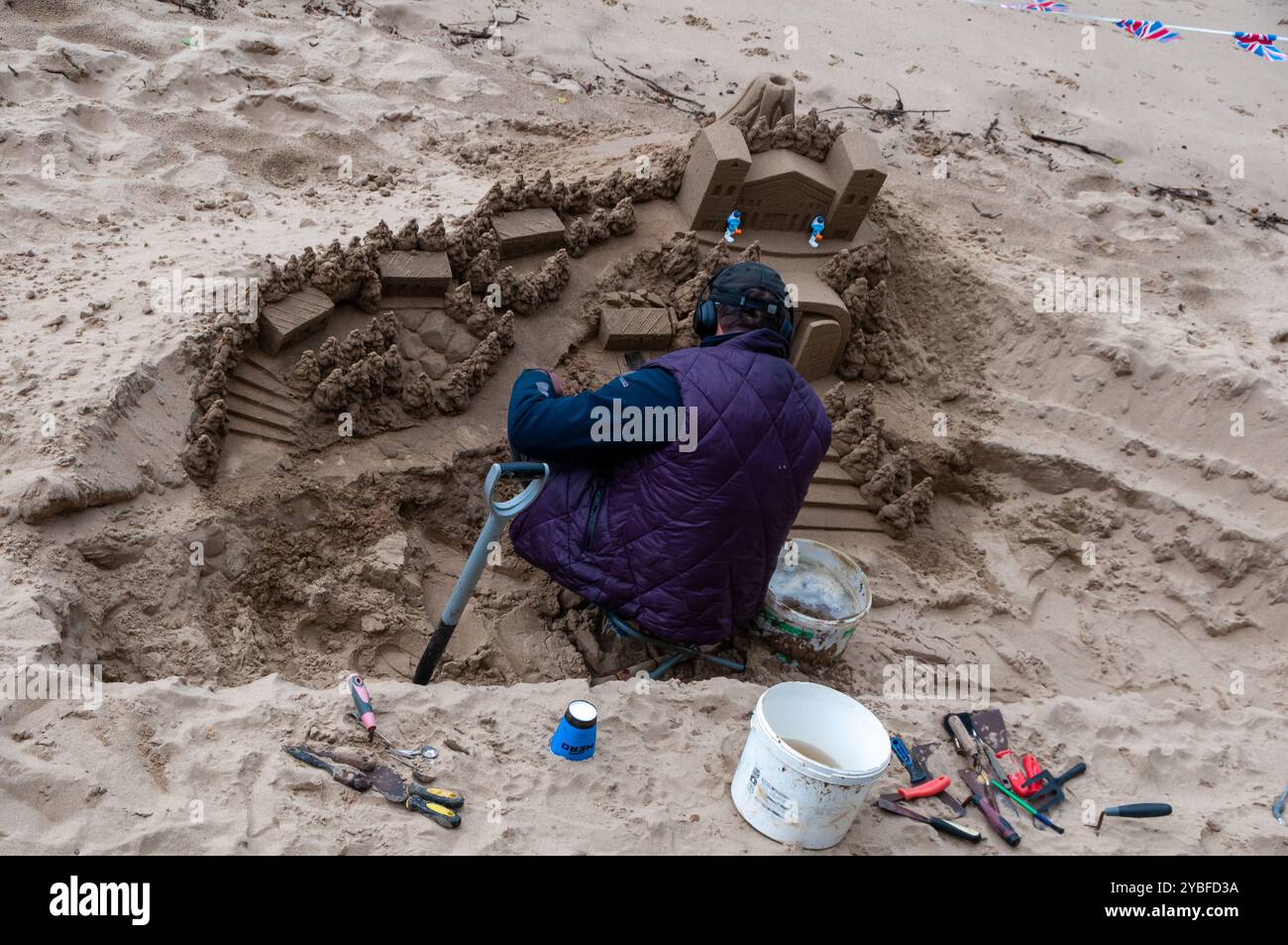 An artist creates a sand sculpture near the River Thames in the South ...