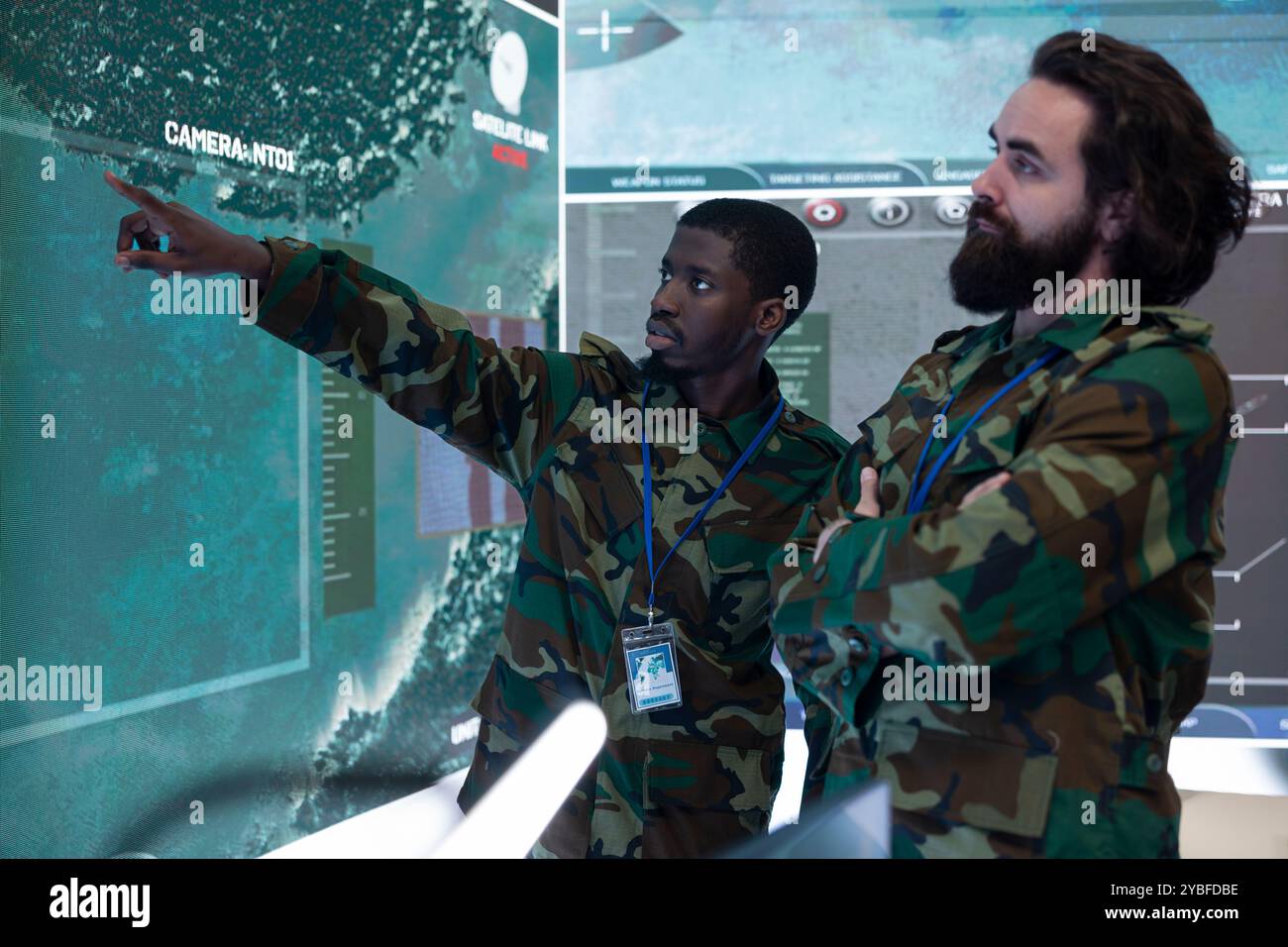 Team of recruits examining new surveillance footage on a big screen ...