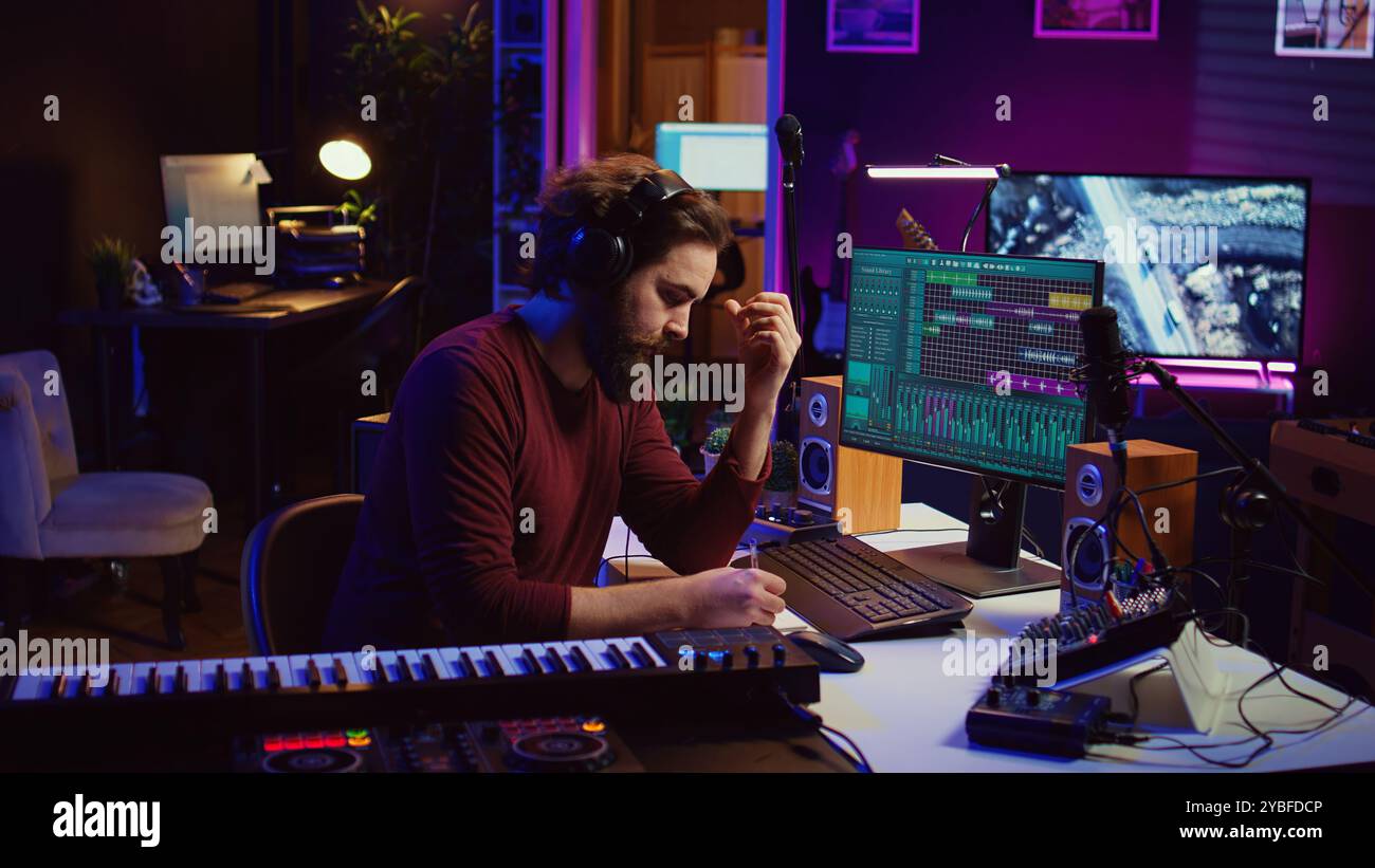 Musician artist taking notes composing new song in his home studio ...