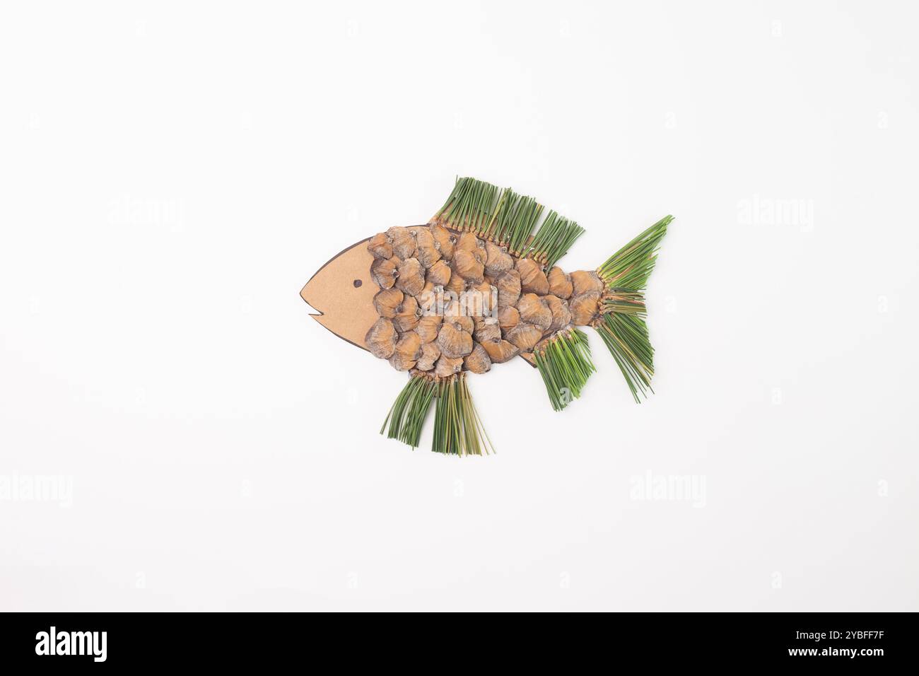 Pine cone fish shape, pine needles, white backdrop. Nature inspired ...
