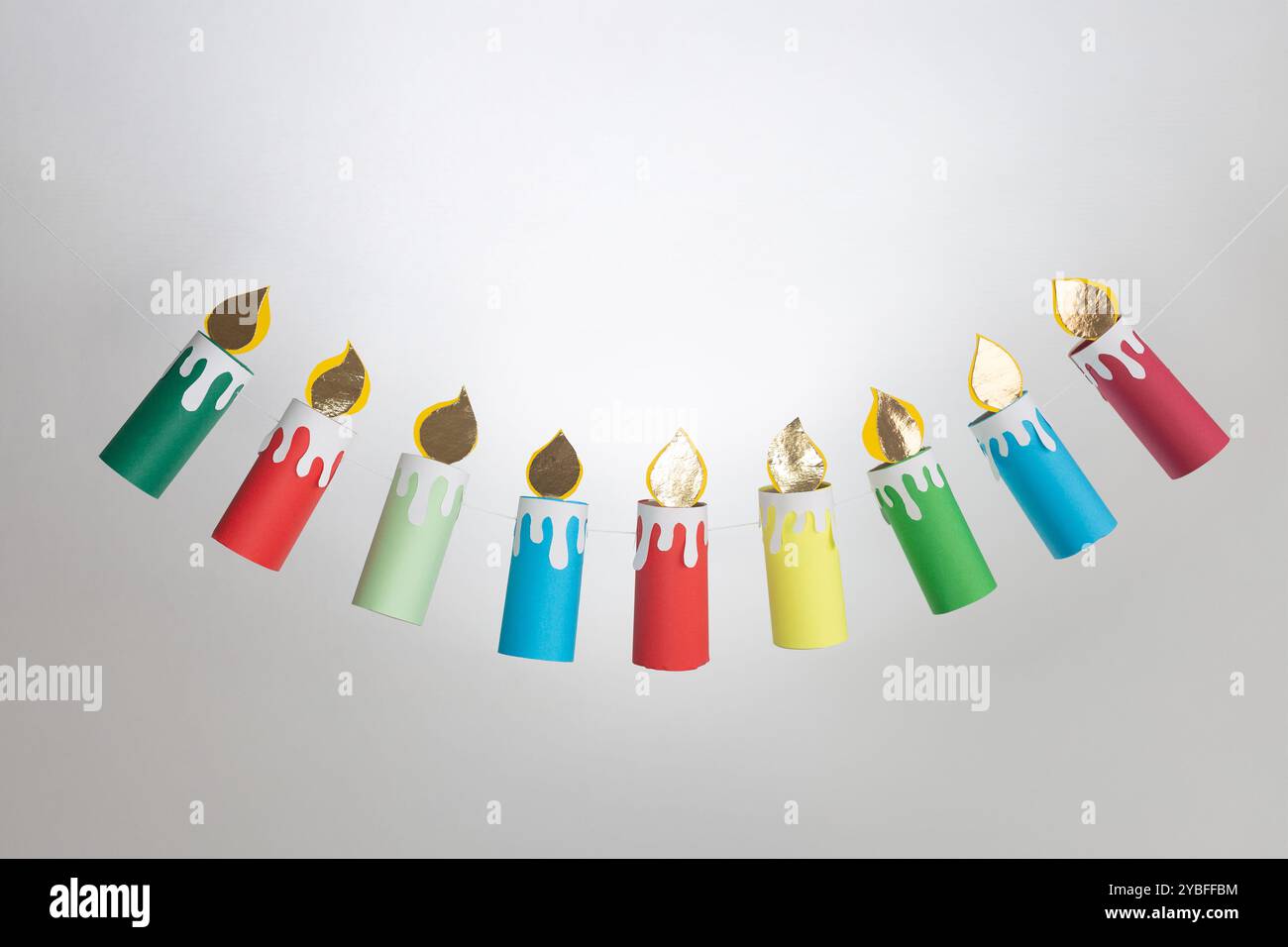 Colorful paper candle garland hanging on a light background. Step in ...