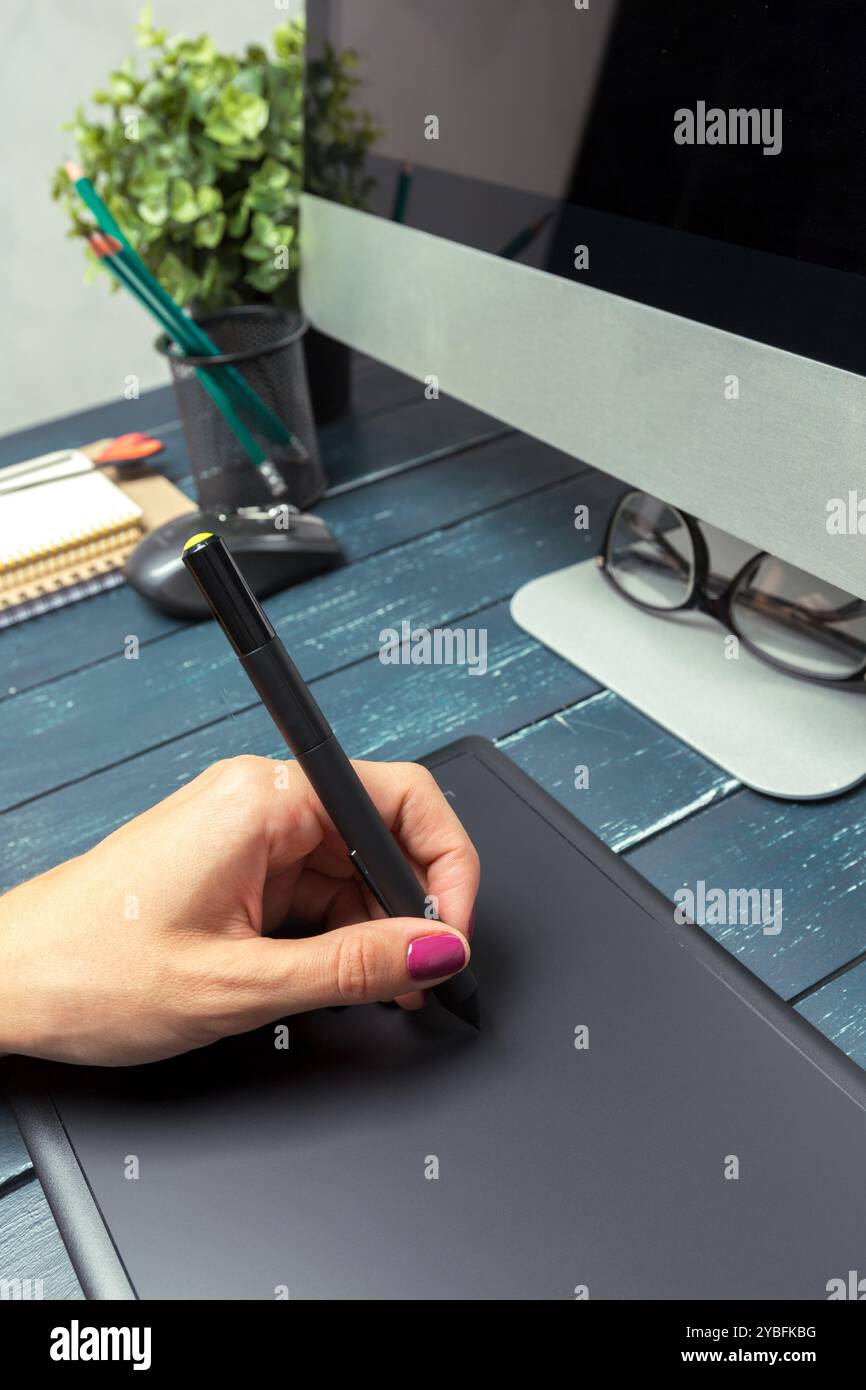 Hand of graphic designer working with stilus and tablet Stock Photo - Alamy