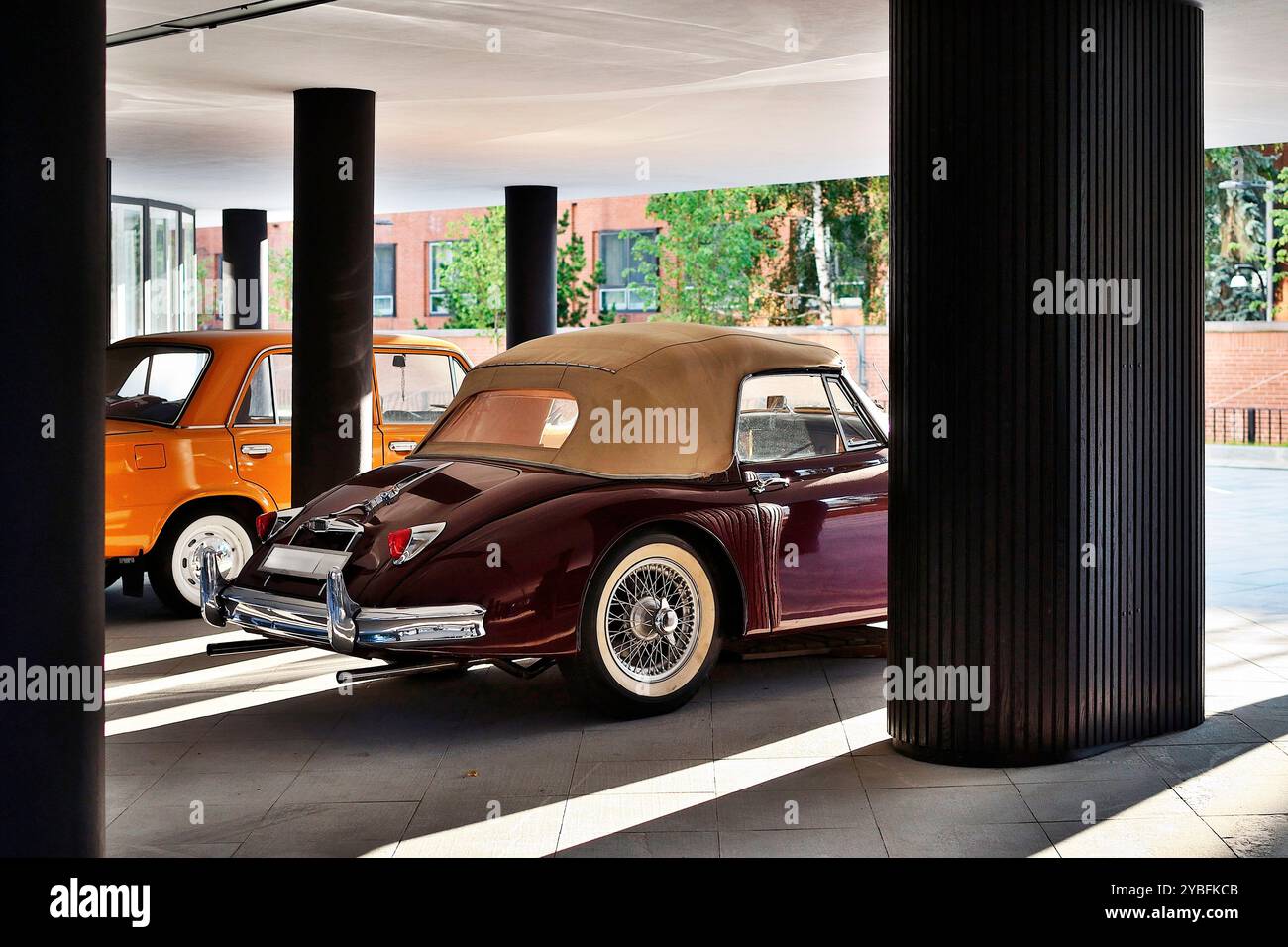 The vintage Jaguar car in the parking lot of the Narkomfin House is one ...