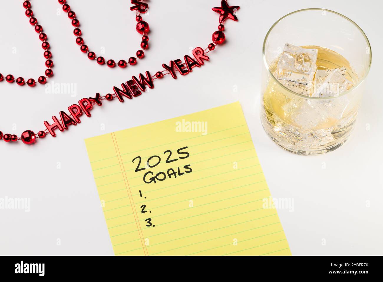 Yellow paper list for 2025 goals at New Year with drink Stock Photo - Alamy