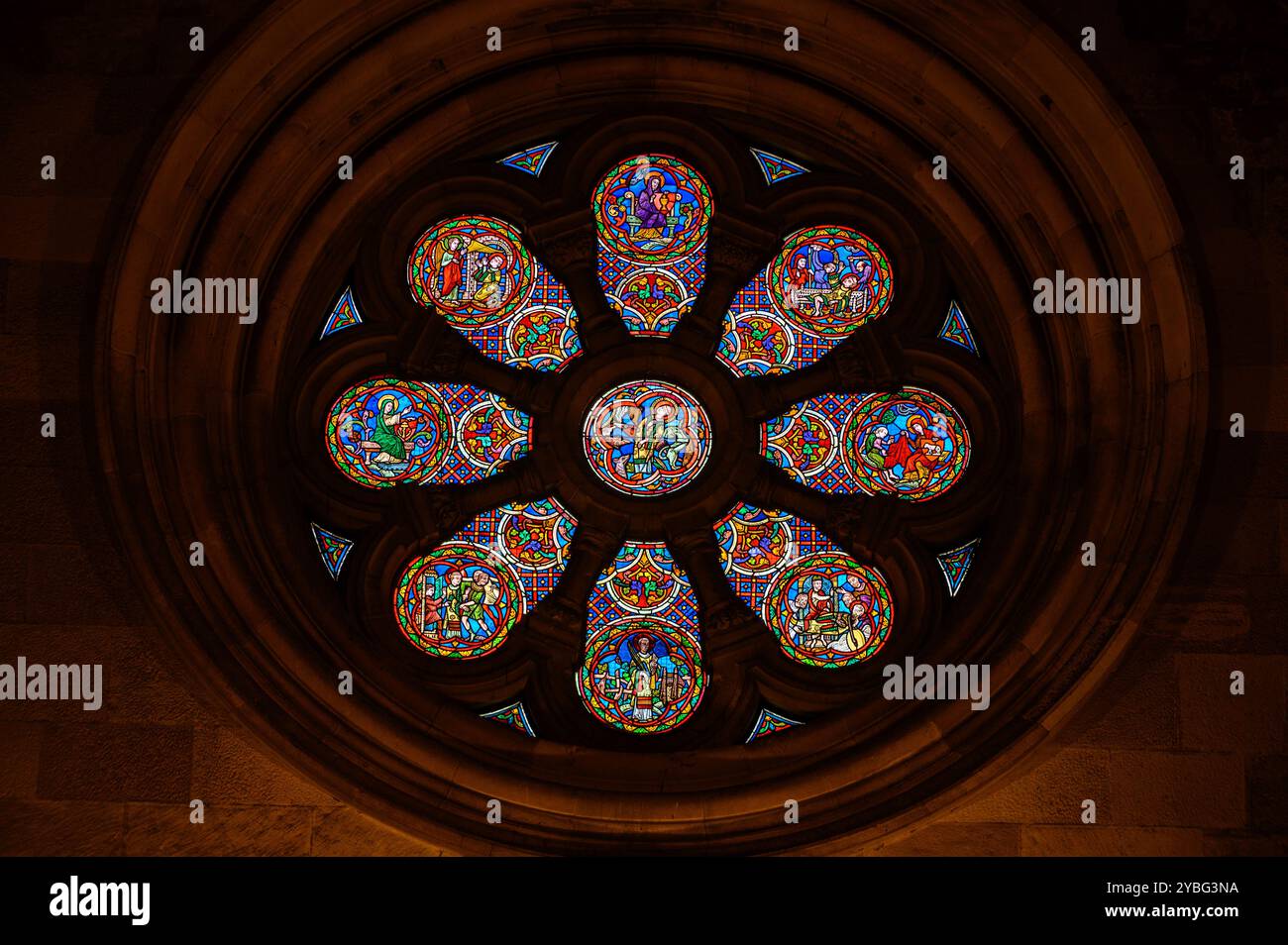 A circular stained-glass window depicting the life of Saint Vincent of ...