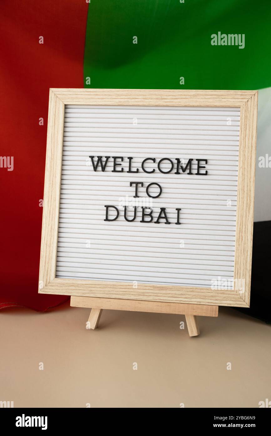 Frame text WELCOME TO DUBAI on background of waving UAE flag made from ...