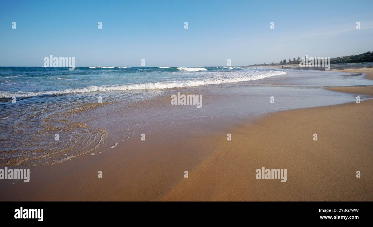 Popular tourist area, sandy beach with surf waves rolling in at Buddina ...