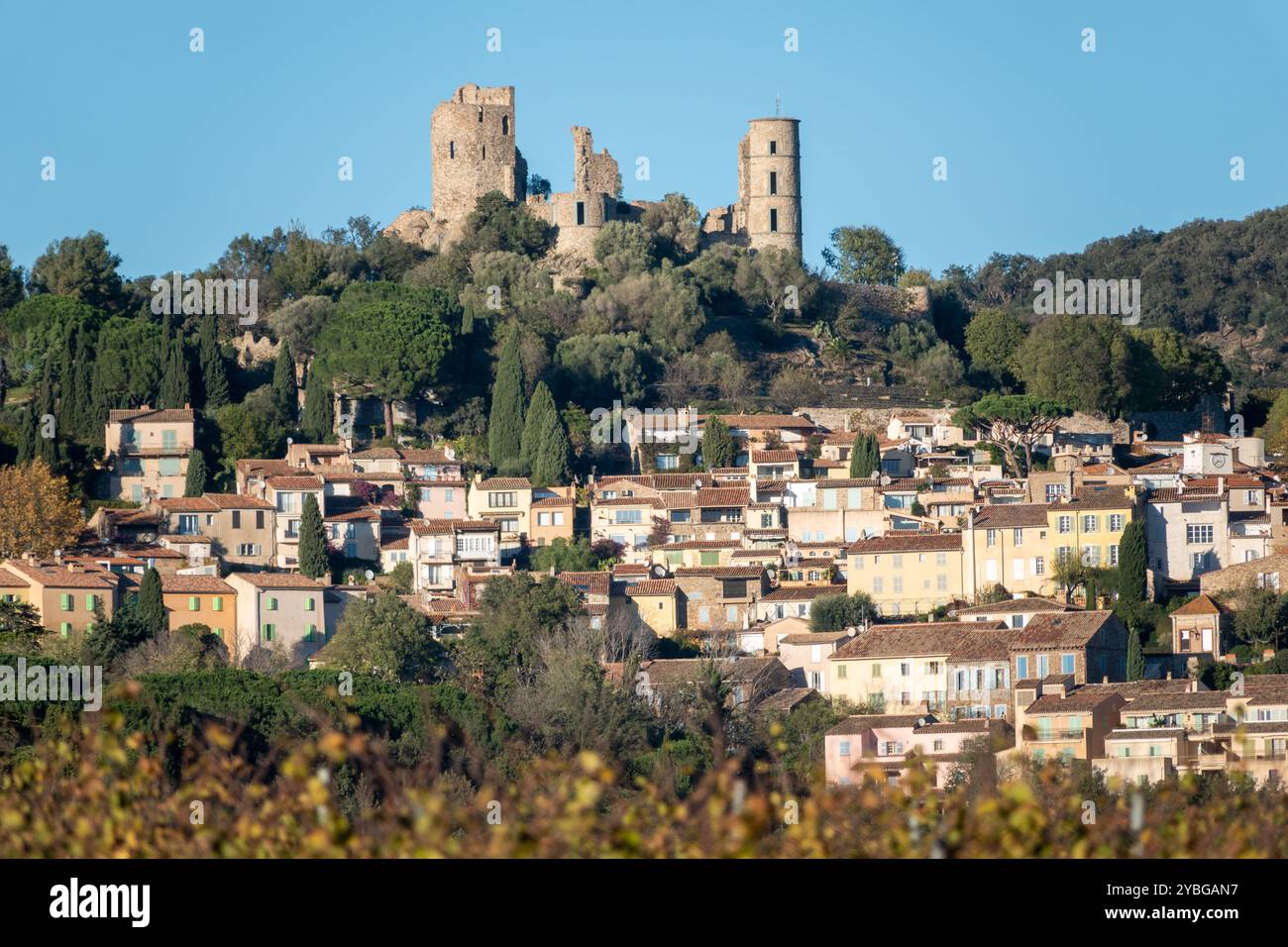 Grimaud a village at the top of a hill with a church, a bell tower and ...