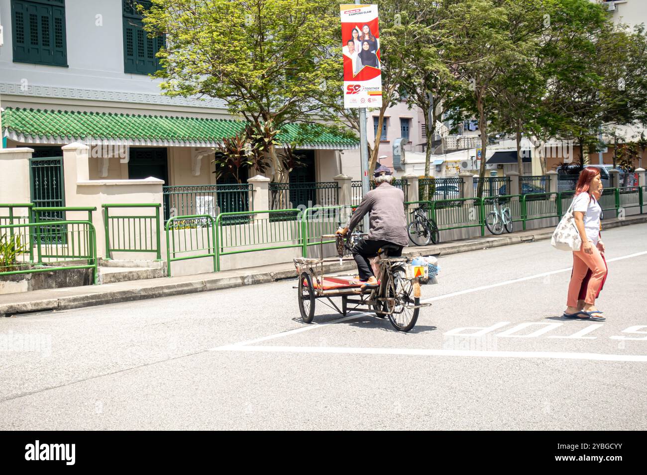 Singapore - man riding tricycle Stock Photo - Alamy